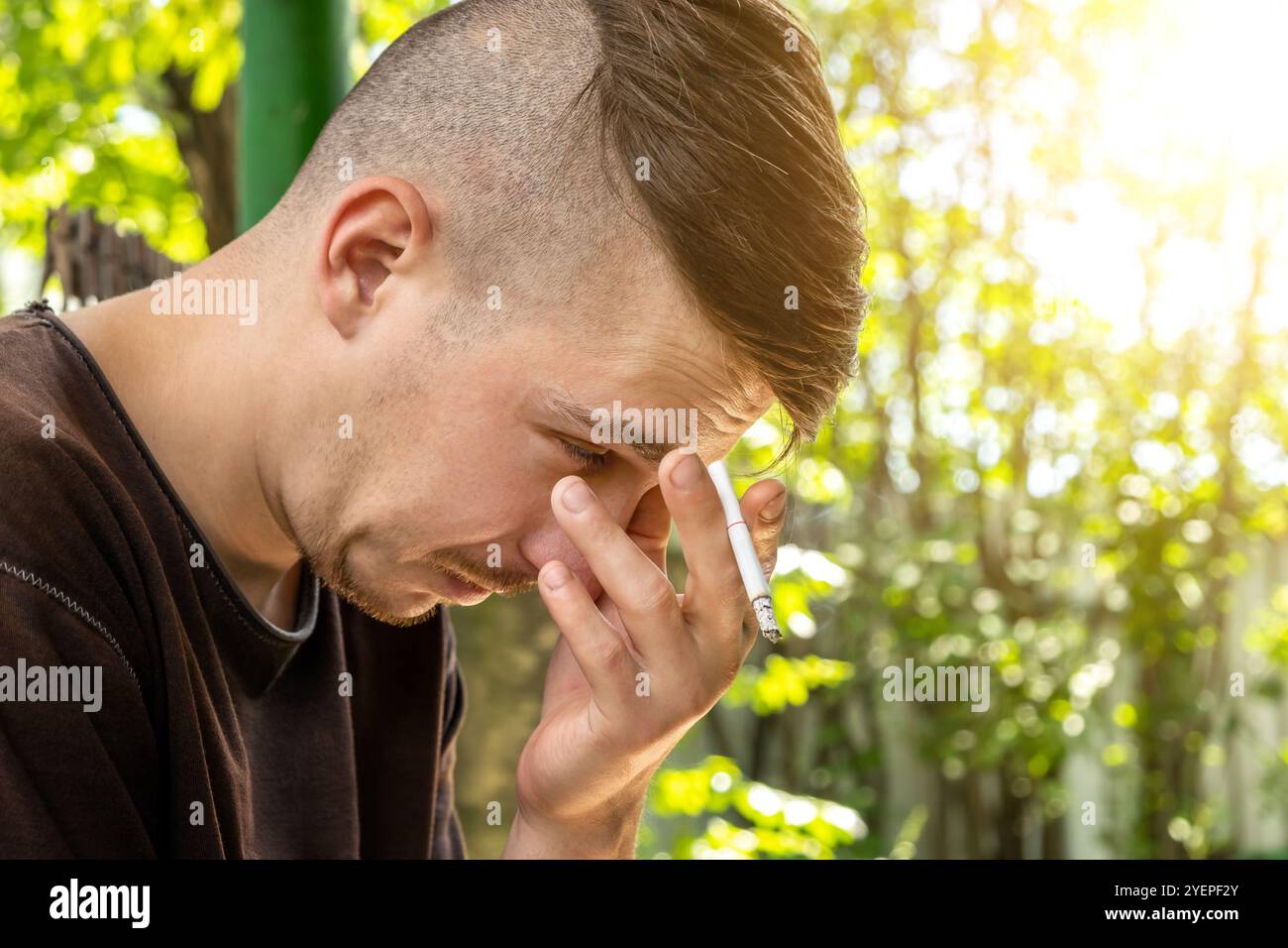 Portrait sad man smoking cigarette hi-res stock photography and images ...