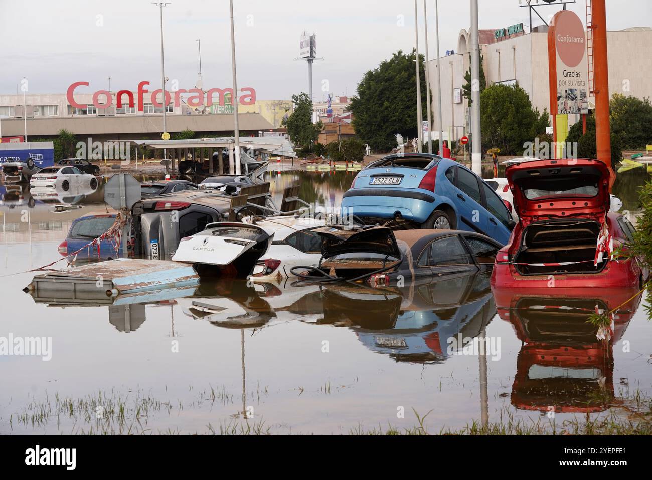 Cars are seen half submerged after floods in Valencia, Spain, Friday ...