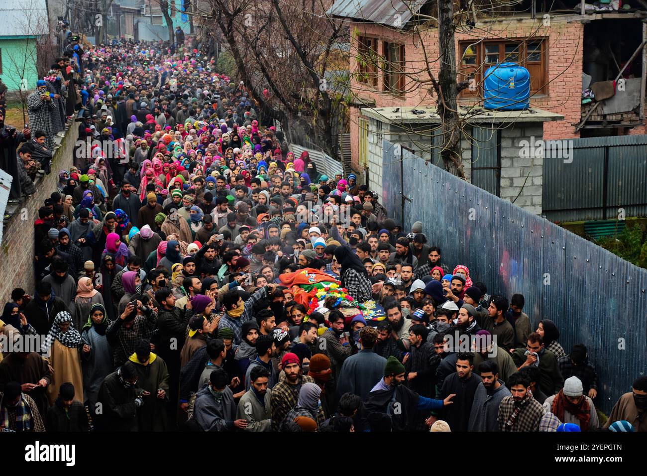 Thousands of mourners carry the body of alleged rebels Mudasir Parray, 14, and Mudasir Parray ...