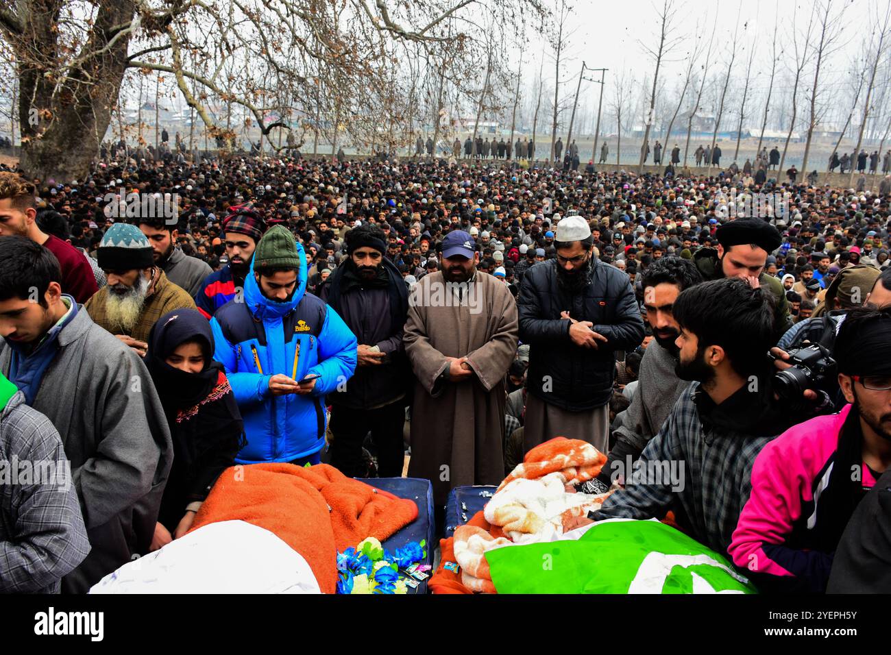 Thousands of mourners carry the body of alleged rebels Mudasir Parray, 14, and Mudasir Parray ...