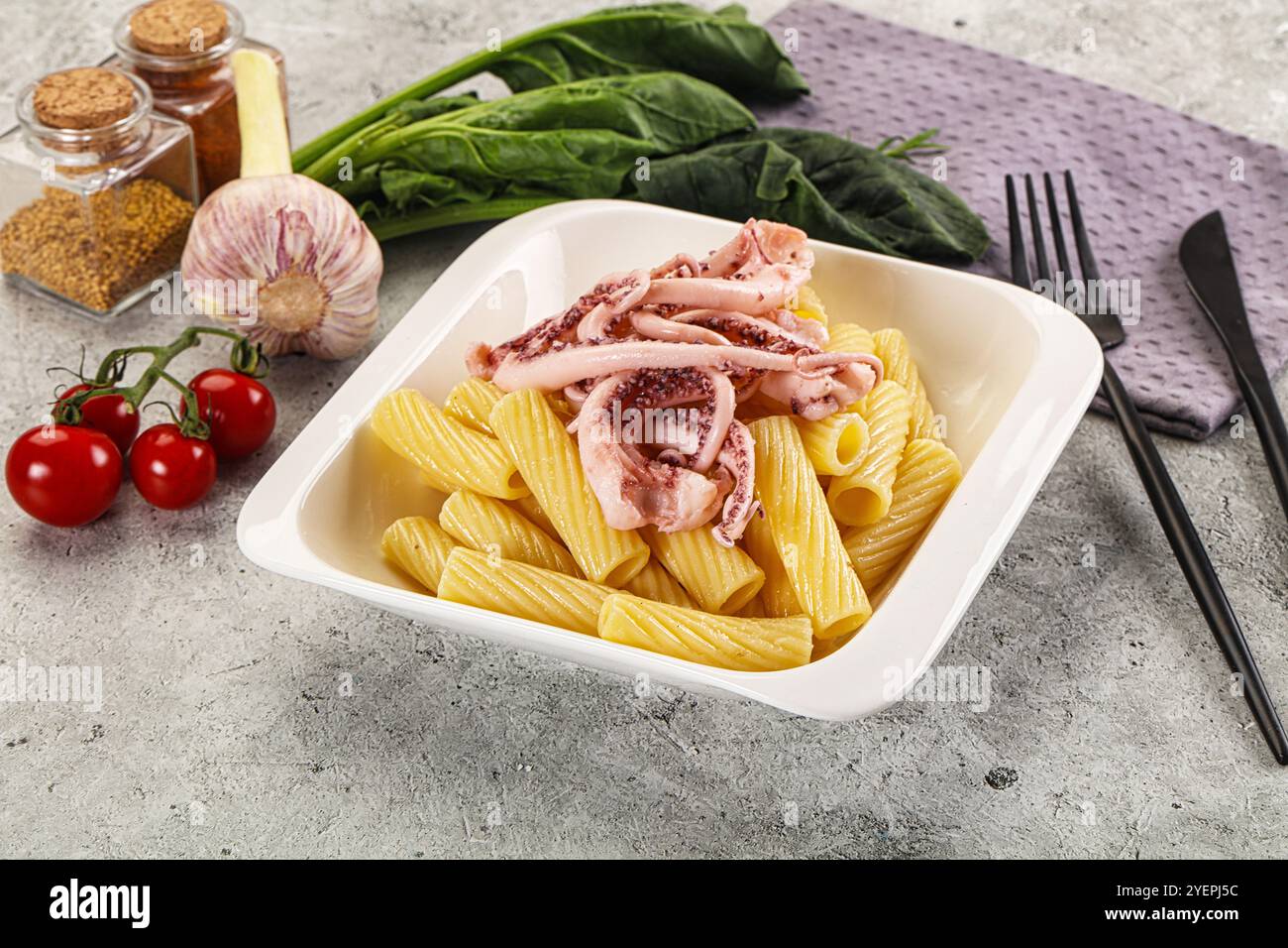 Italian cuisine - pasta tortiglioni with squid tentacles Stock Photo ...