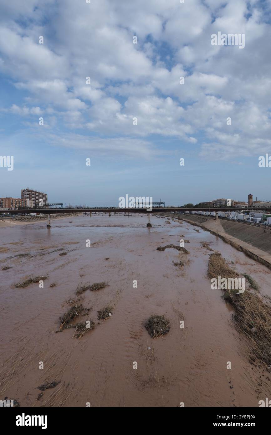 The aftermath of hurricane Dana in Valencia, Spain - Muddy river flowing through city after ...