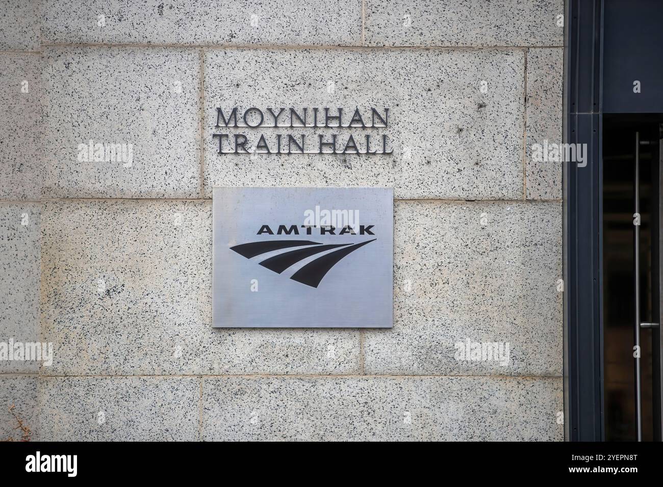 "Moynihan Train Hall" inscribed on it. Below the inscription is a metal ...