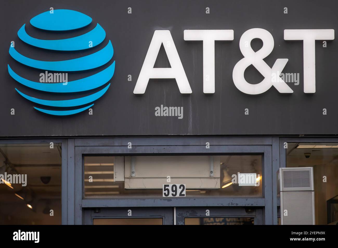 ATandT store sign, showcasing the iconic blue globe logo and white lettering, positioned above ...