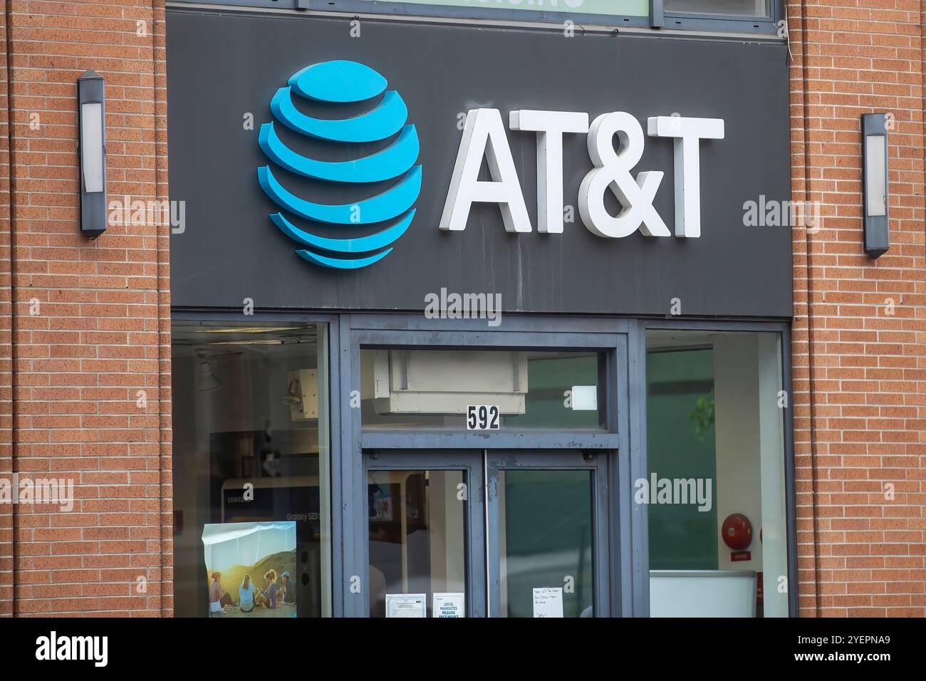ATandT store sign, showcasing the iconic blue globe logo and white lettering, positioned above ...