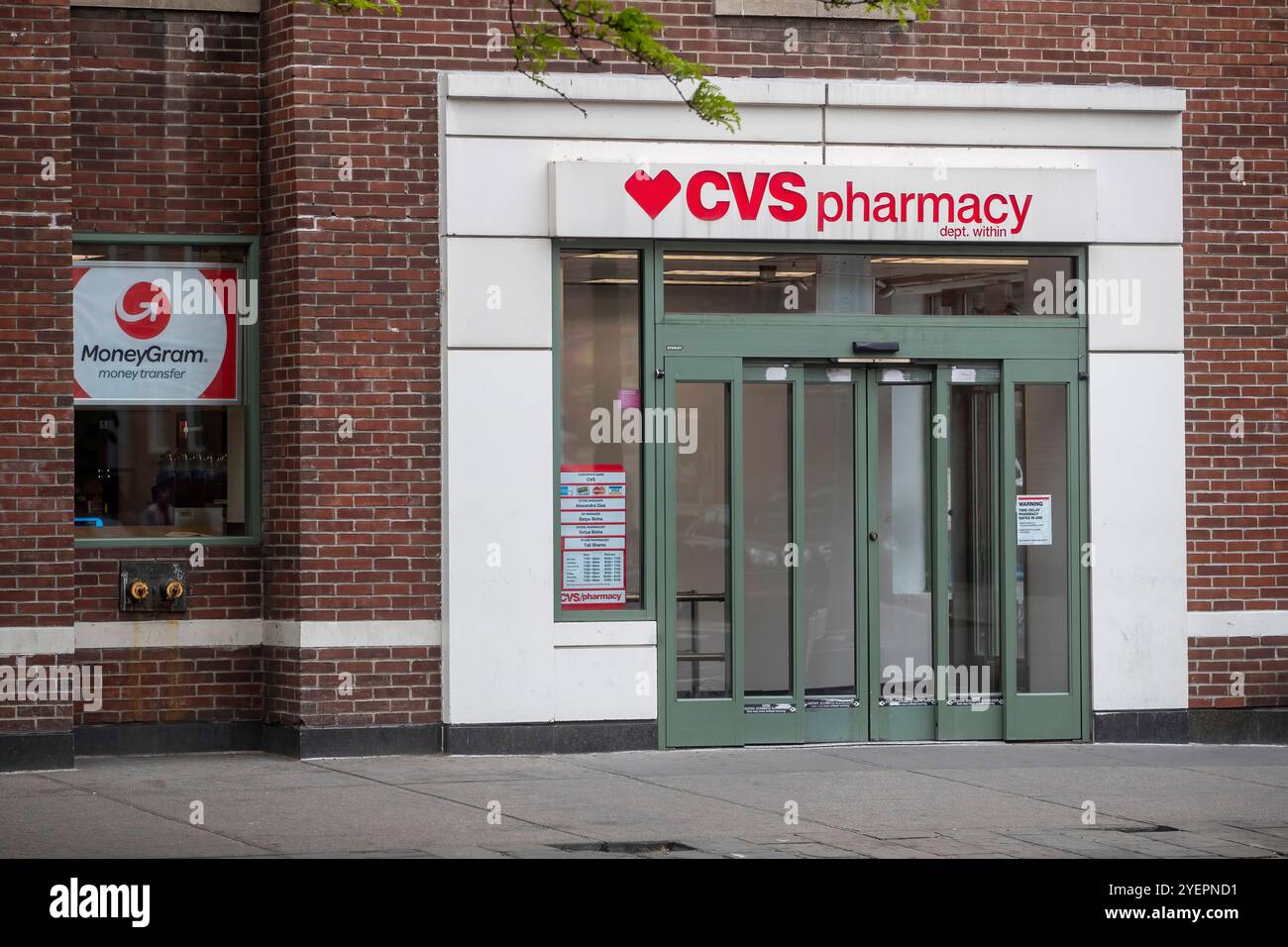 This image shows the storefront of a CVS Pharmacy, with its bold red ...
