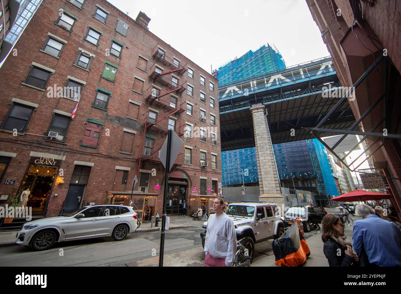 This image captures a street scene in DUMBO, Brooklyn, with people ...