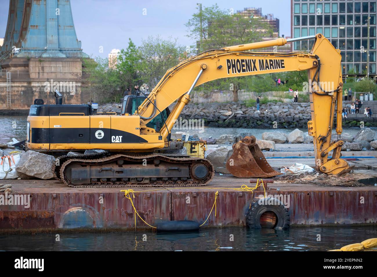 Photograph of a CAT excavator labeled "Phoenix Marine" parked on a ...