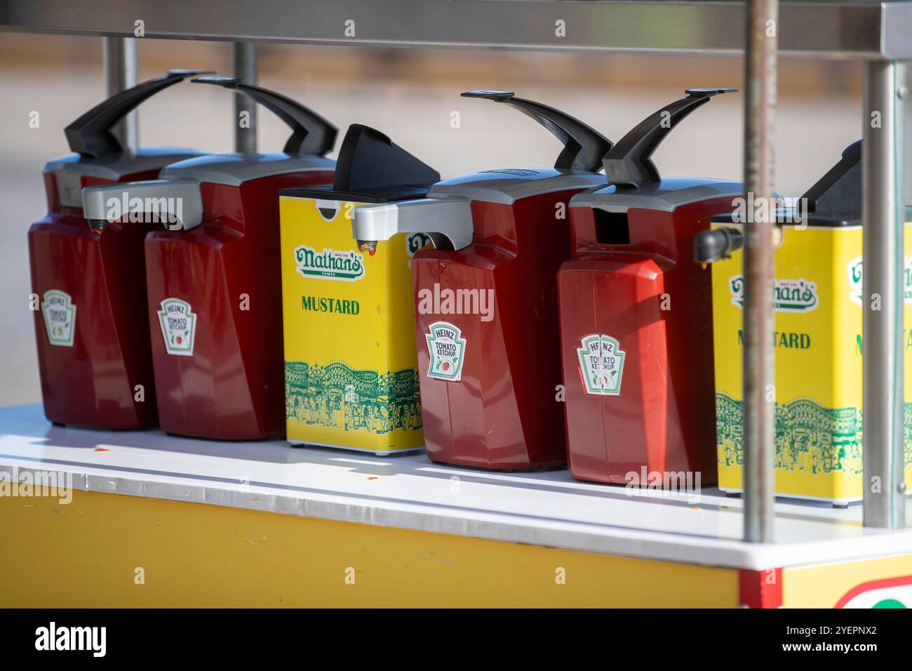 This image captures a condiment station from Nathan's Famous, featuring ...