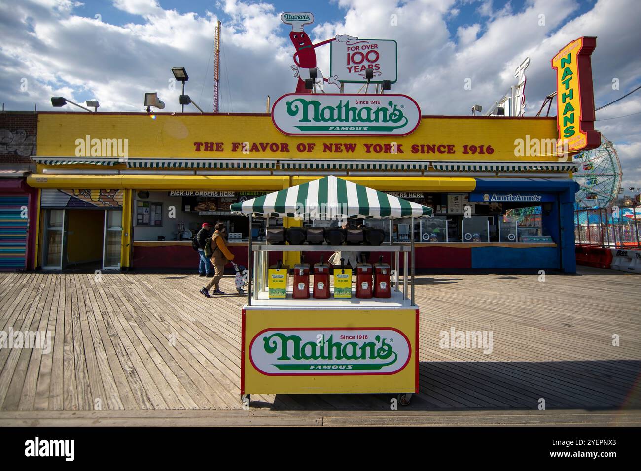 This image captures a condiment station from Nathan's Famous, featuring ...