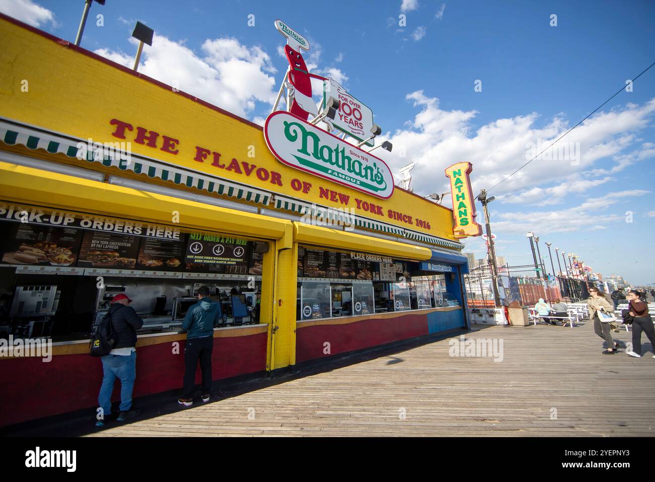 This image showcases the iconic signage of Nathan's Famous, a well ...