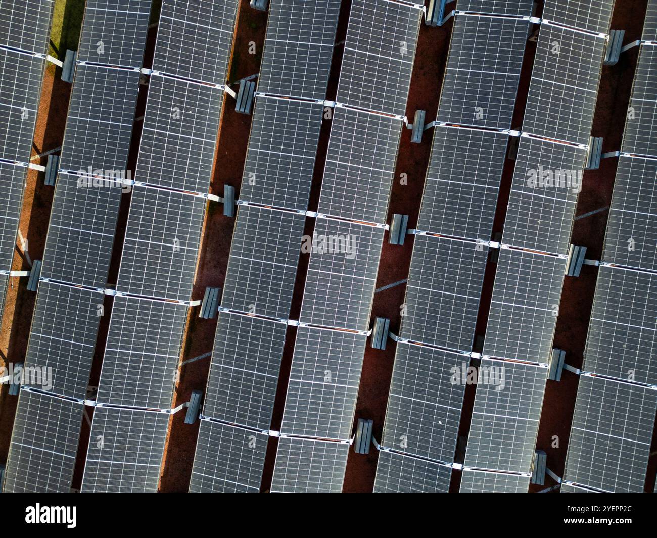 Aerial drone view of solar panels arranged in rows, capturing the ...