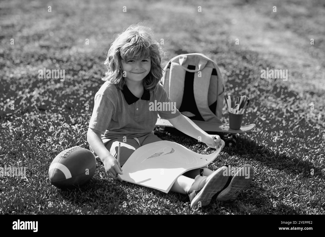 Kid painter draw on playground. Clever school boy doing homework ...