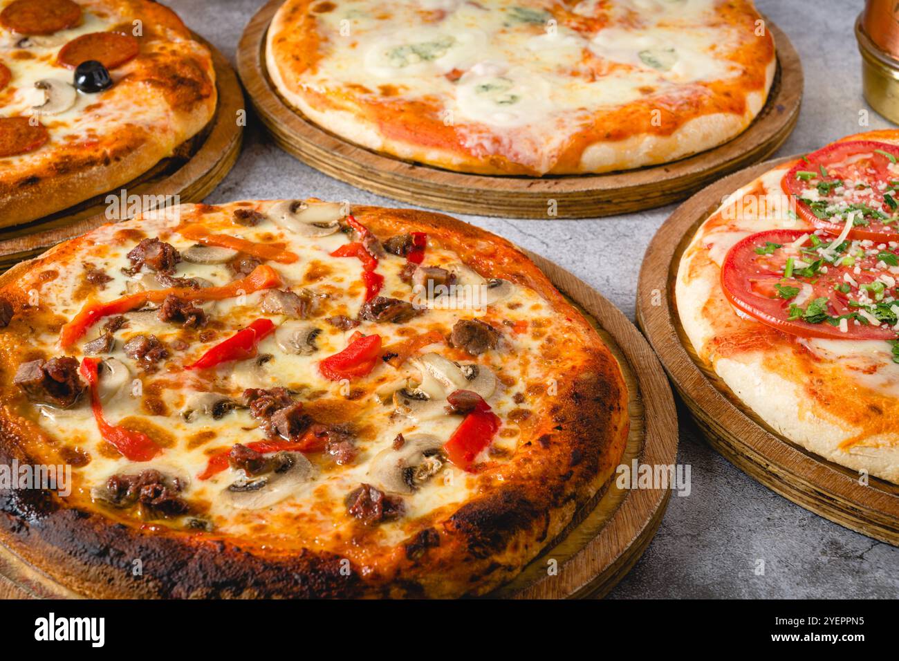 Top view of various neapolitan pizzas on grey stone table Stock Photo ...
