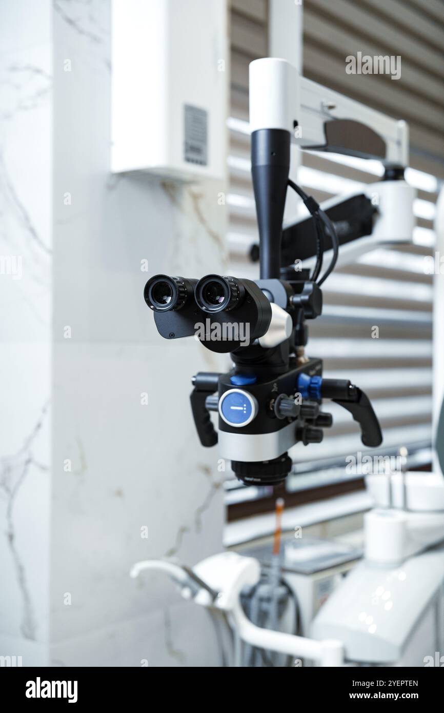 A detailed view of a dental microscope prepared for a procedure in a ...