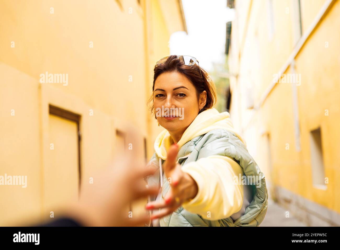 Woman reaching out her hand in a playful gesture Stock Photo - Alamy
