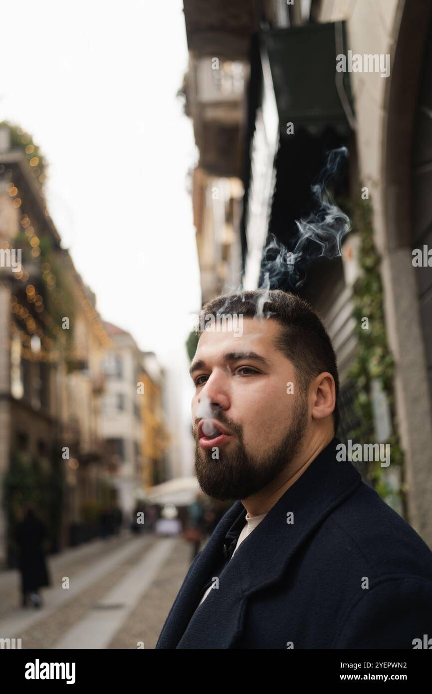 Closeup portrait of a handsome man smoking, Milan, Italy Stock Photo ...