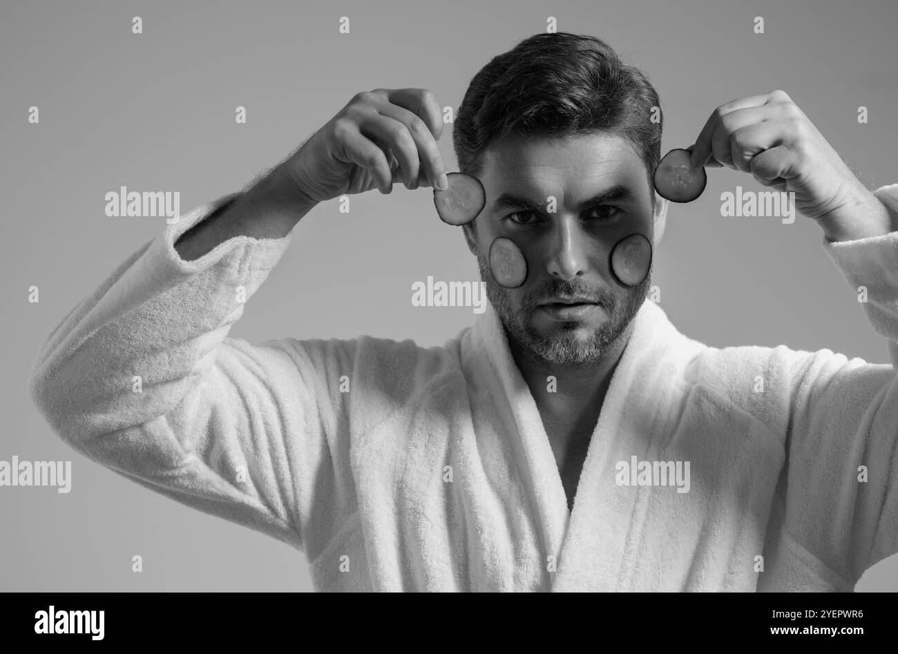 Beauty man hold cucumber for cosmetology mask. Middle aged man with ...