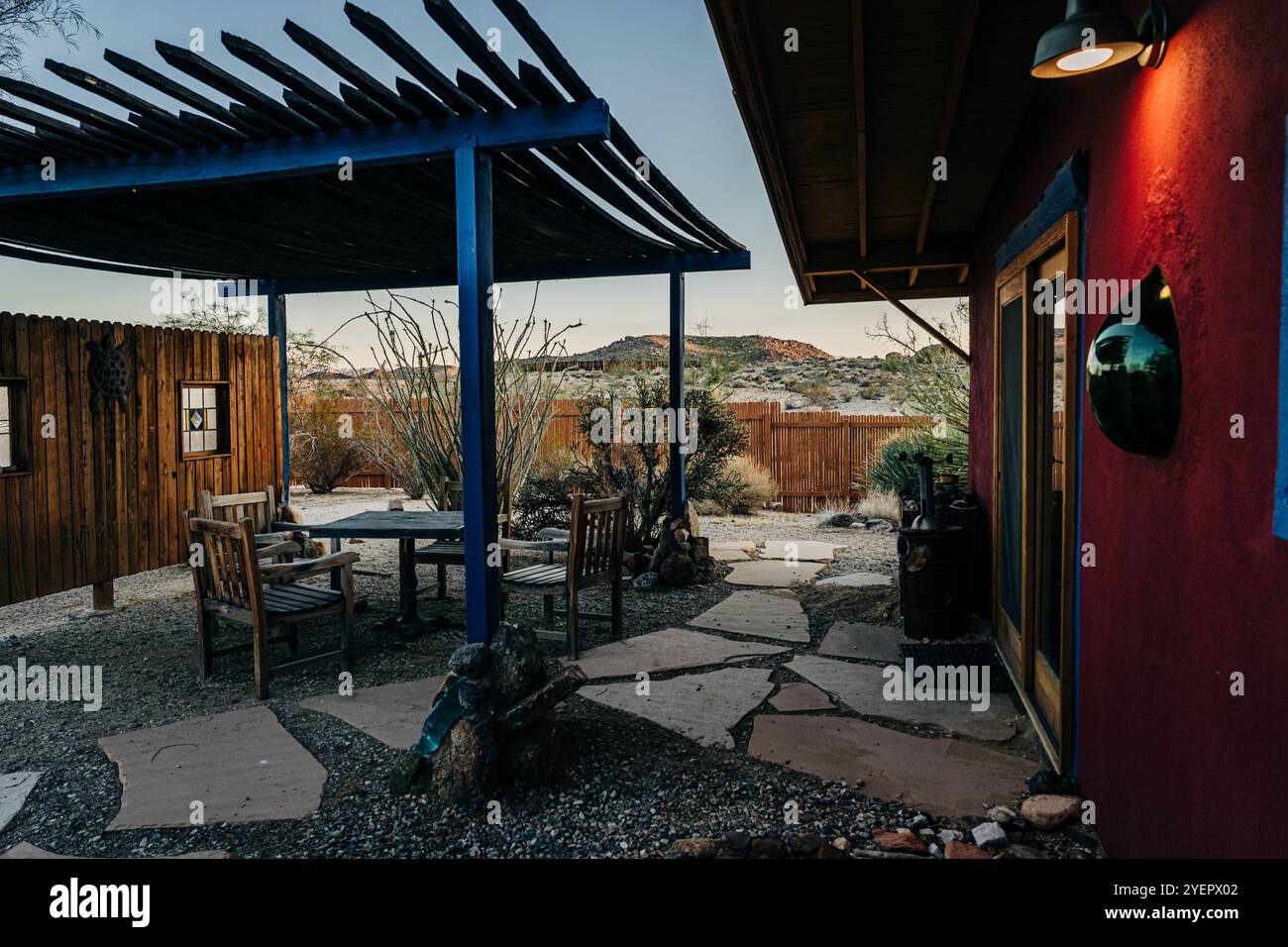 Rustic patio with wooden seating, pergola, and desert landscape Stock ...