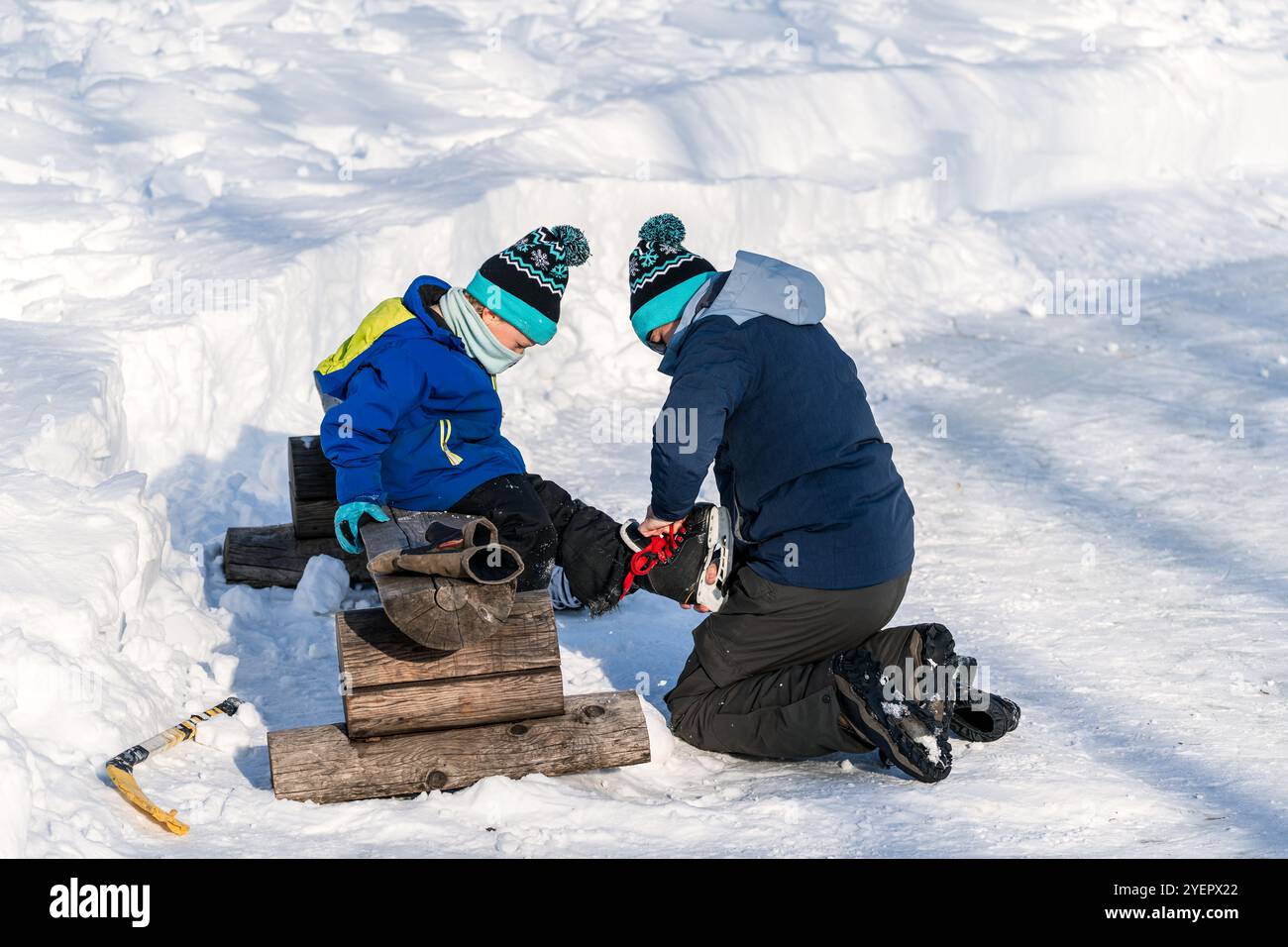 Father helping son put on ice skates Stock Photo - Alamy Father helping son put on ice skates Stock Photo - Alamy