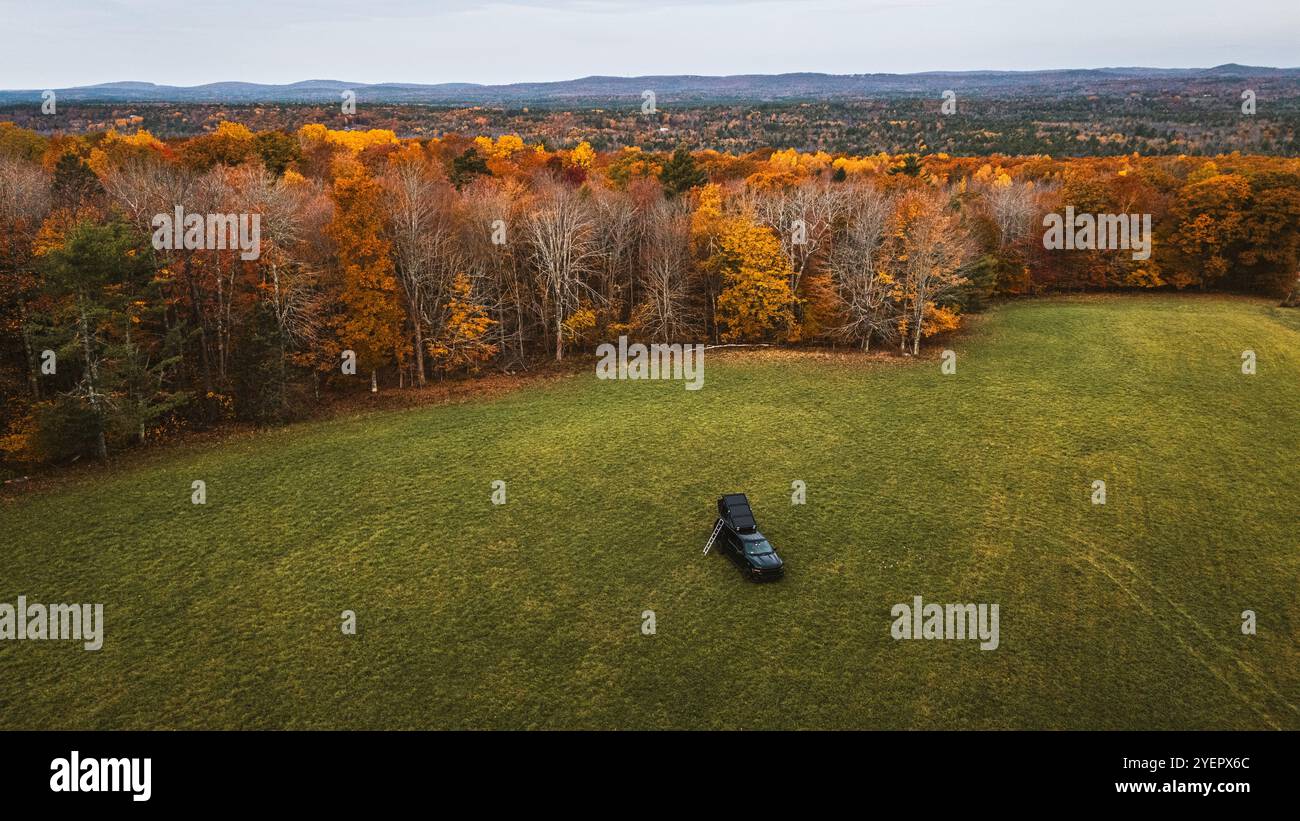 Overlanding truck parked in remote field campsite in Maine in fall ...