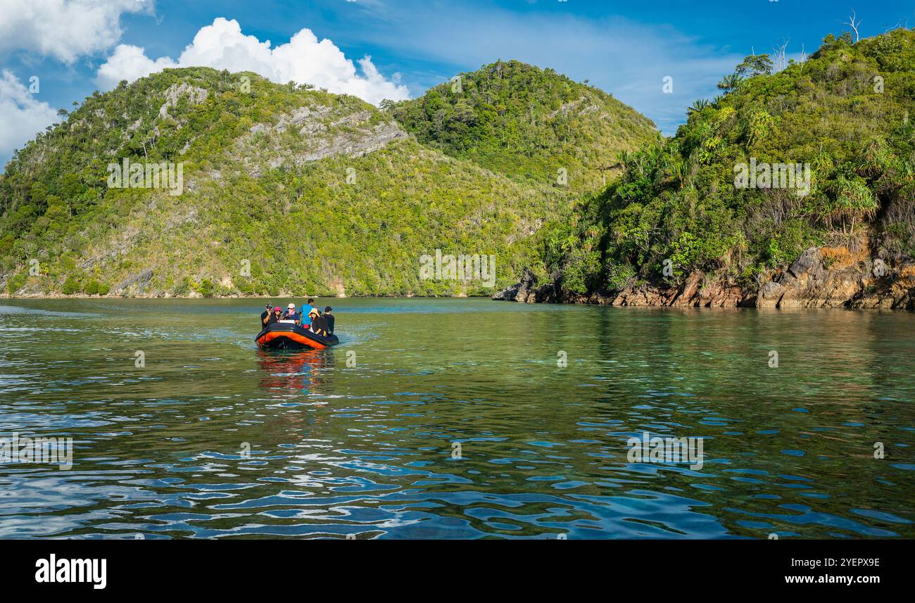 group of people approaching island in Raja Ampat Stock Photo - Alamy