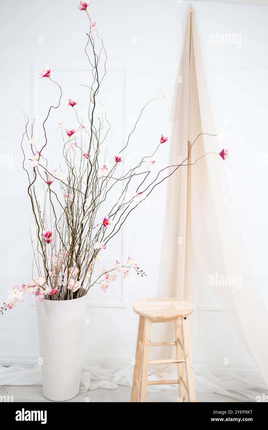 Floral Branch Arrangement with Stool & Fabric Drape Stock Photo - Alamy