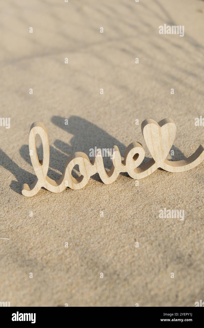 Wooden word love on sandy beach background. Concept of romantic holiday ...