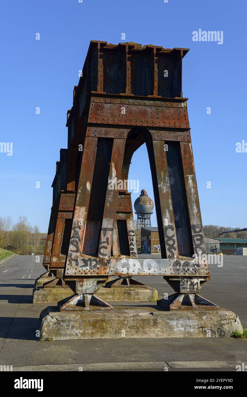 Rusty steel structures with graffiti in front of a clear blue sky in an ...