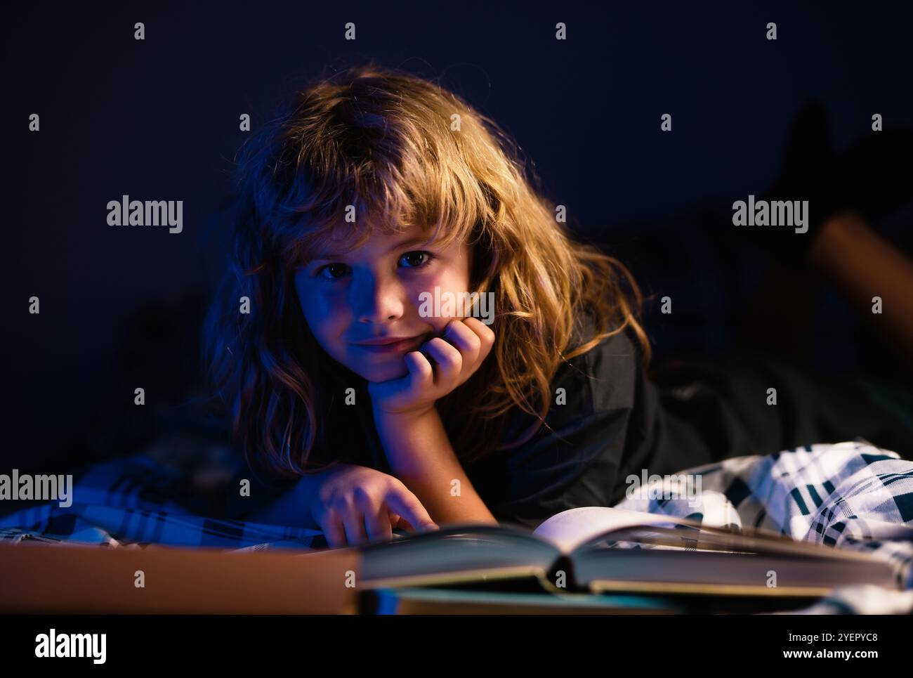 Child read fairy tale from book. Child reading a book in bed before ...