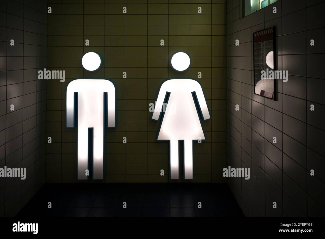 Backlit large symbols in entrance to public convenience Stock Photo - Alamy