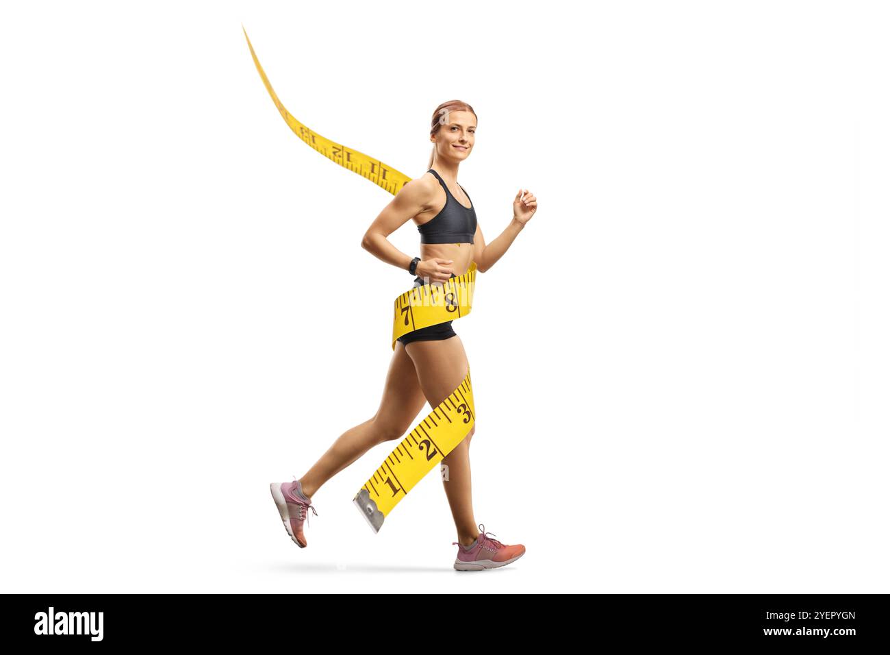 Full length shot of a fit woman in sportswear jogging with measure tape ...