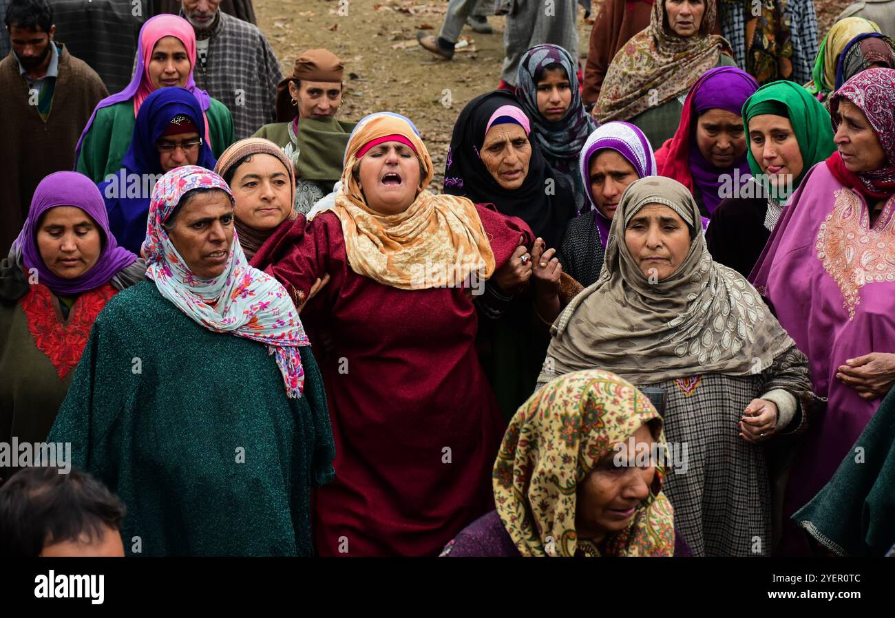 Thousands of mourners carry the body of alleged rebels Mudasir Parray, 14, and Mudasir Parray ...
