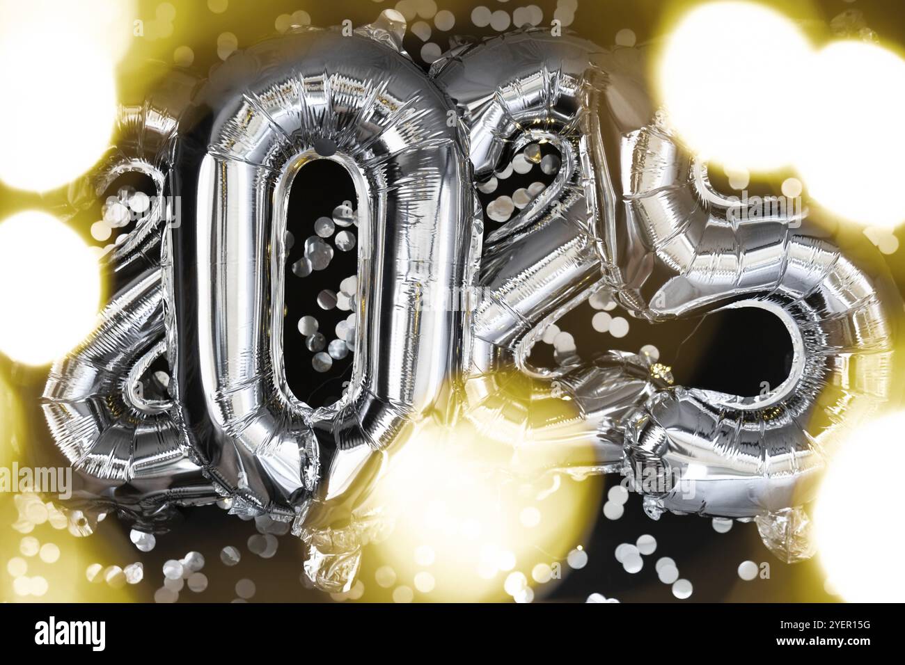 Holiday bokeh garland Happy new year 2025 metallic balloons with confetti on dark black ...