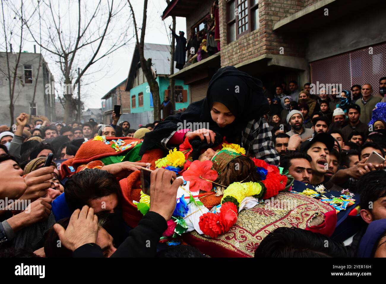 Thousands of mourners carry the body of alleged rebels Mudasir Parray, 14, and Mudasir Parray ...