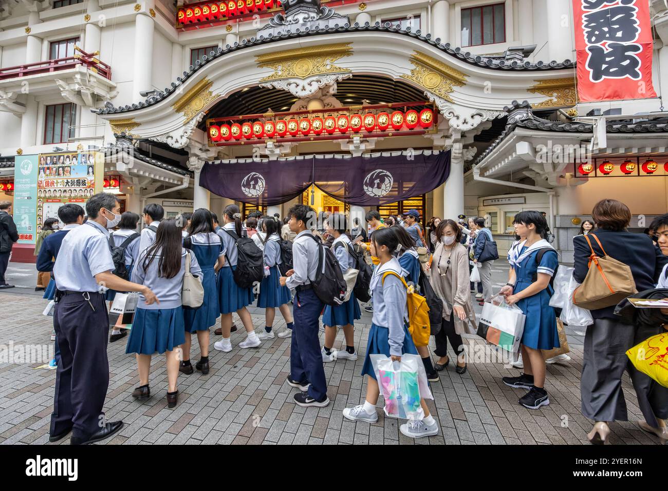 Queue of Japanese schoolchildren waiting to enter the Kabukiza Theatre ...