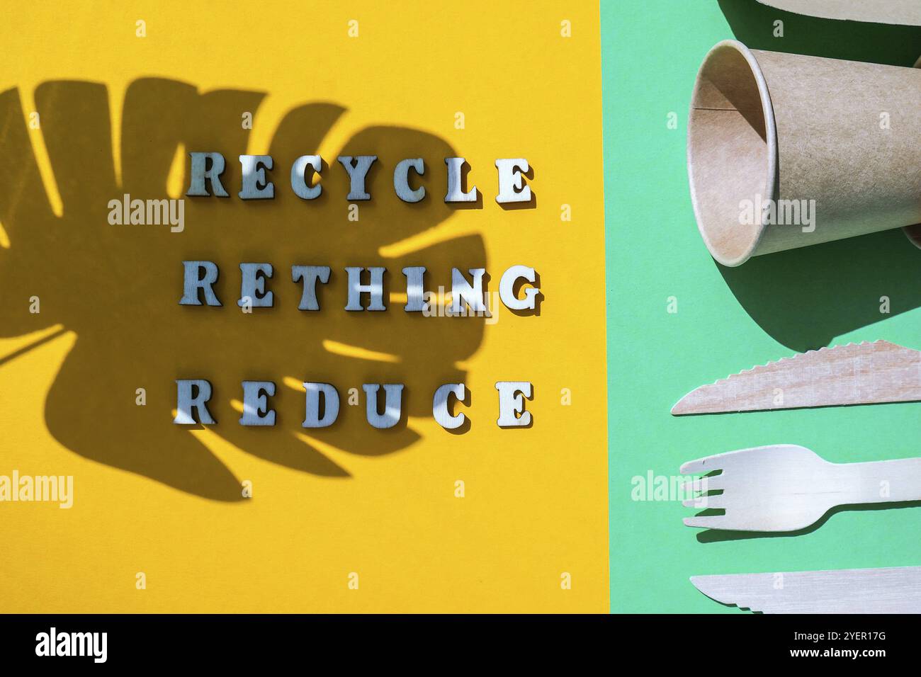 RECYCLE RETHING REDUCE text Wooden forks and paper cups with plates on ...