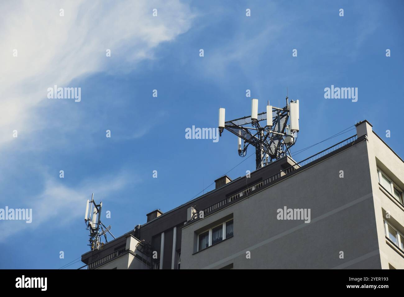 5G radio transmitter residential Building Rooftop Cell Tower. Cell phone communication antenna ...