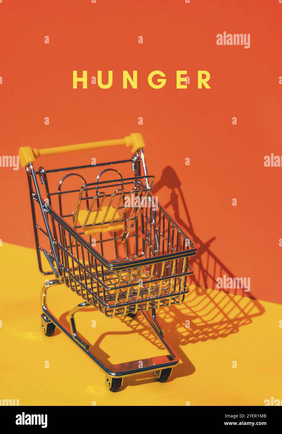 HUNGER text against Empty shopping trolley cart on isometric orange ...