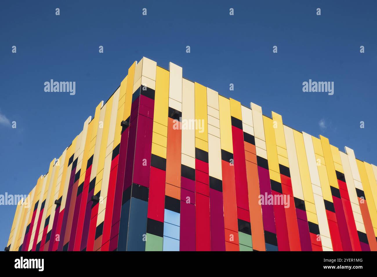 Modern colorful office building exterior with glass facade on clear sky ...