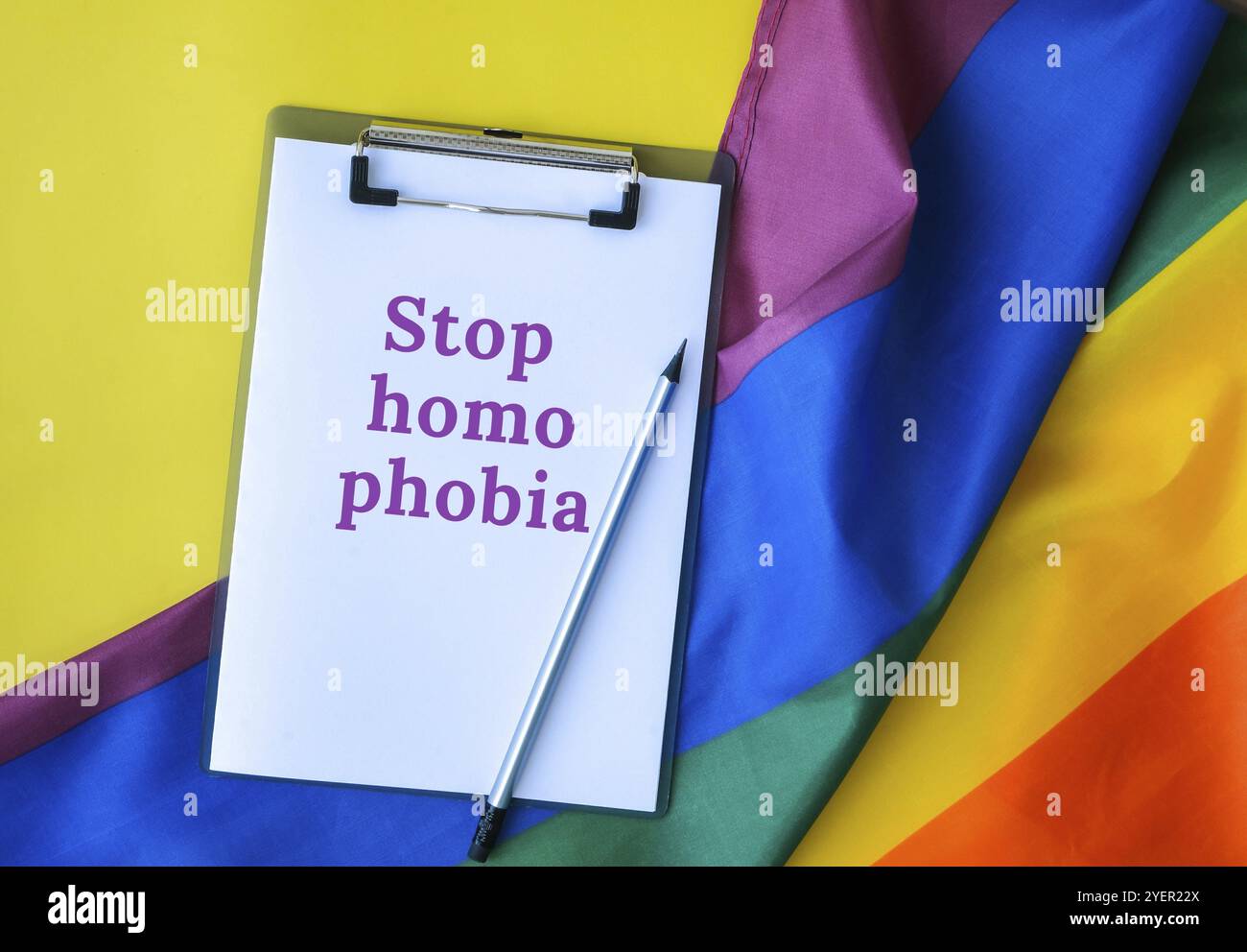 Rainbow flag with text STOP HOMOPHOBIA message paper note. Rainbow ...