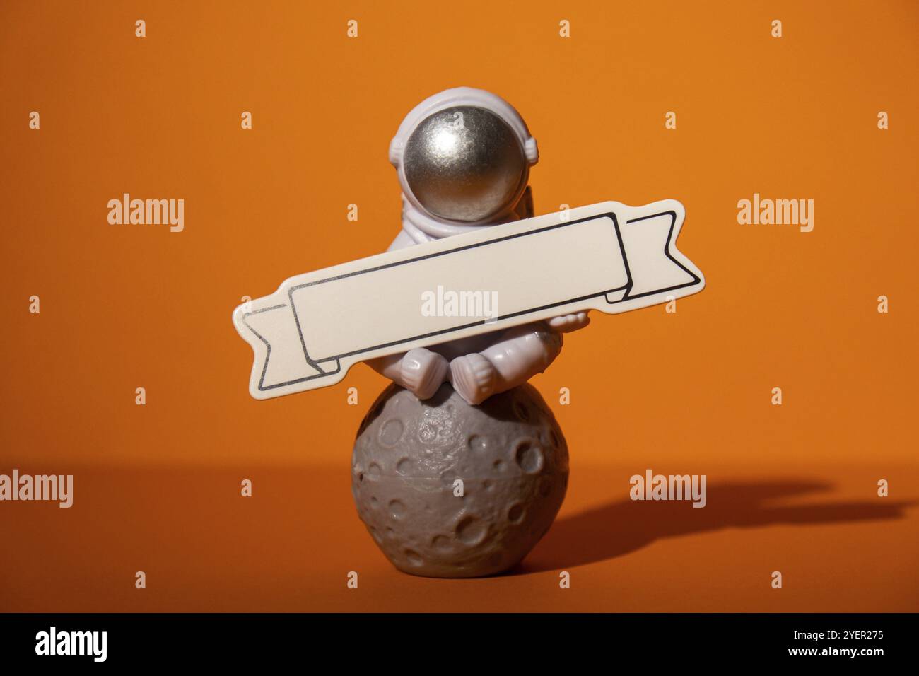 Plastic toy astronaut with paper note template mock up for your text on ...