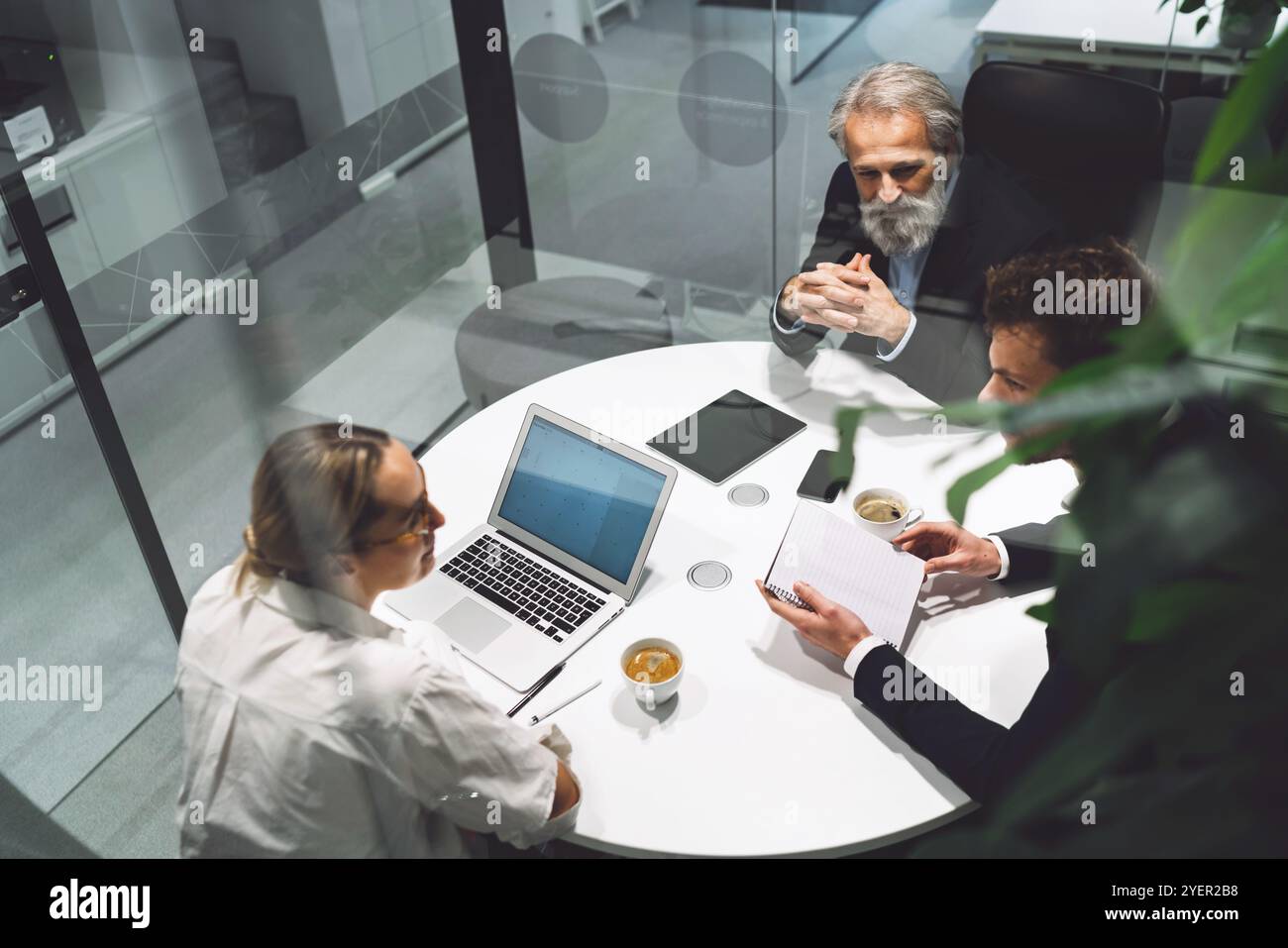 Office full of caucasian business people of different ages working at ...