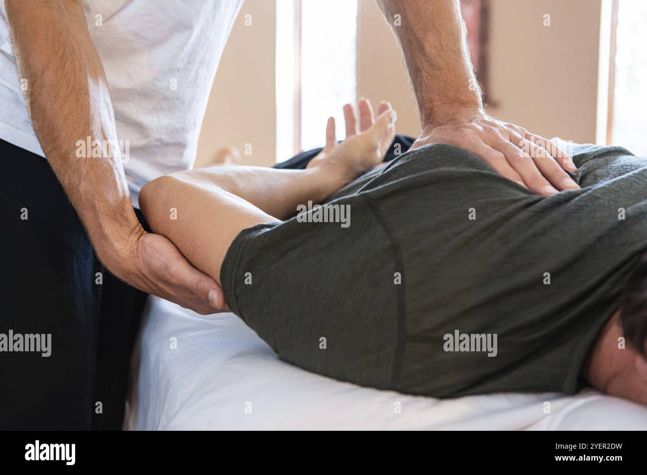 Male masseur therapist hands doing on strong male therapeutic body massage. Professional ...