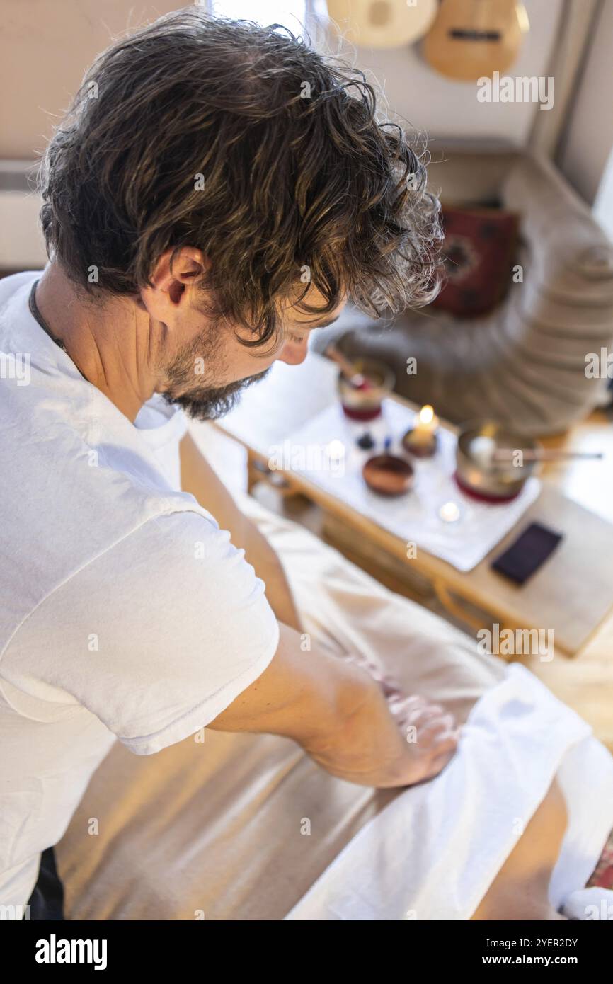 A professional masseur giving a treating massage for a young woman ...