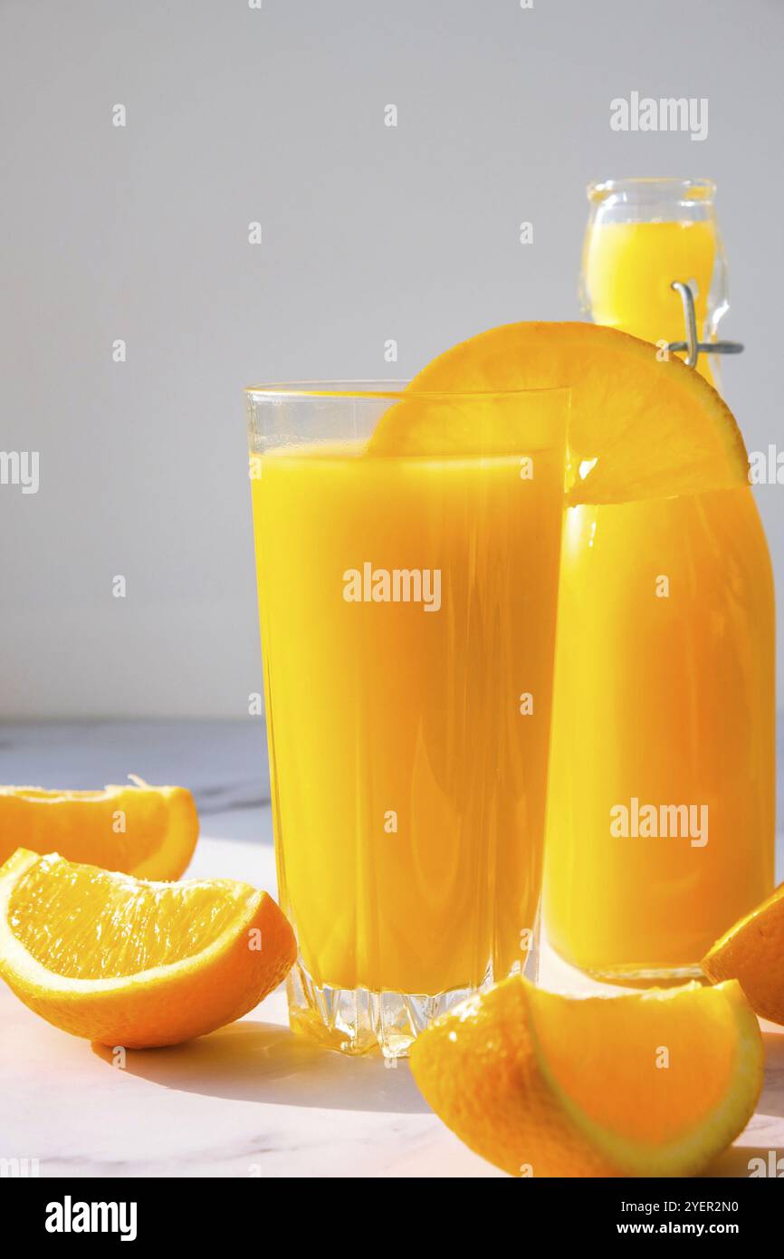 Glass bottle of fresh squeezing Orange juice with sliced fruits on ...