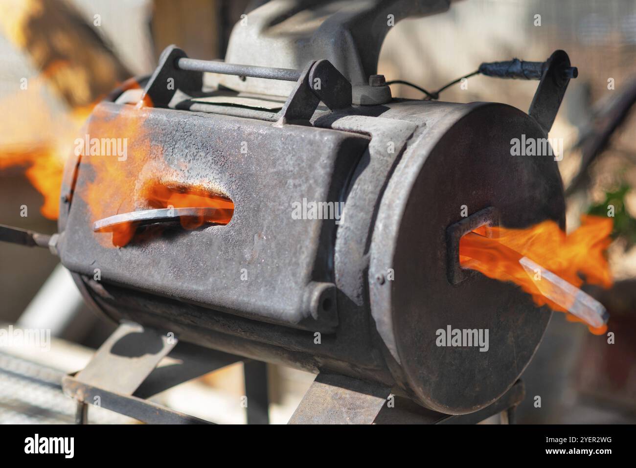 Metal melting in a small portable forge Stock Photo - Alamy