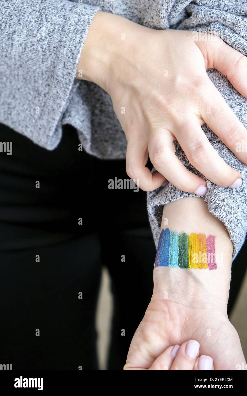 Rainbow LGBTQ flag painted on hand. Support for lgbt community. Honour ...