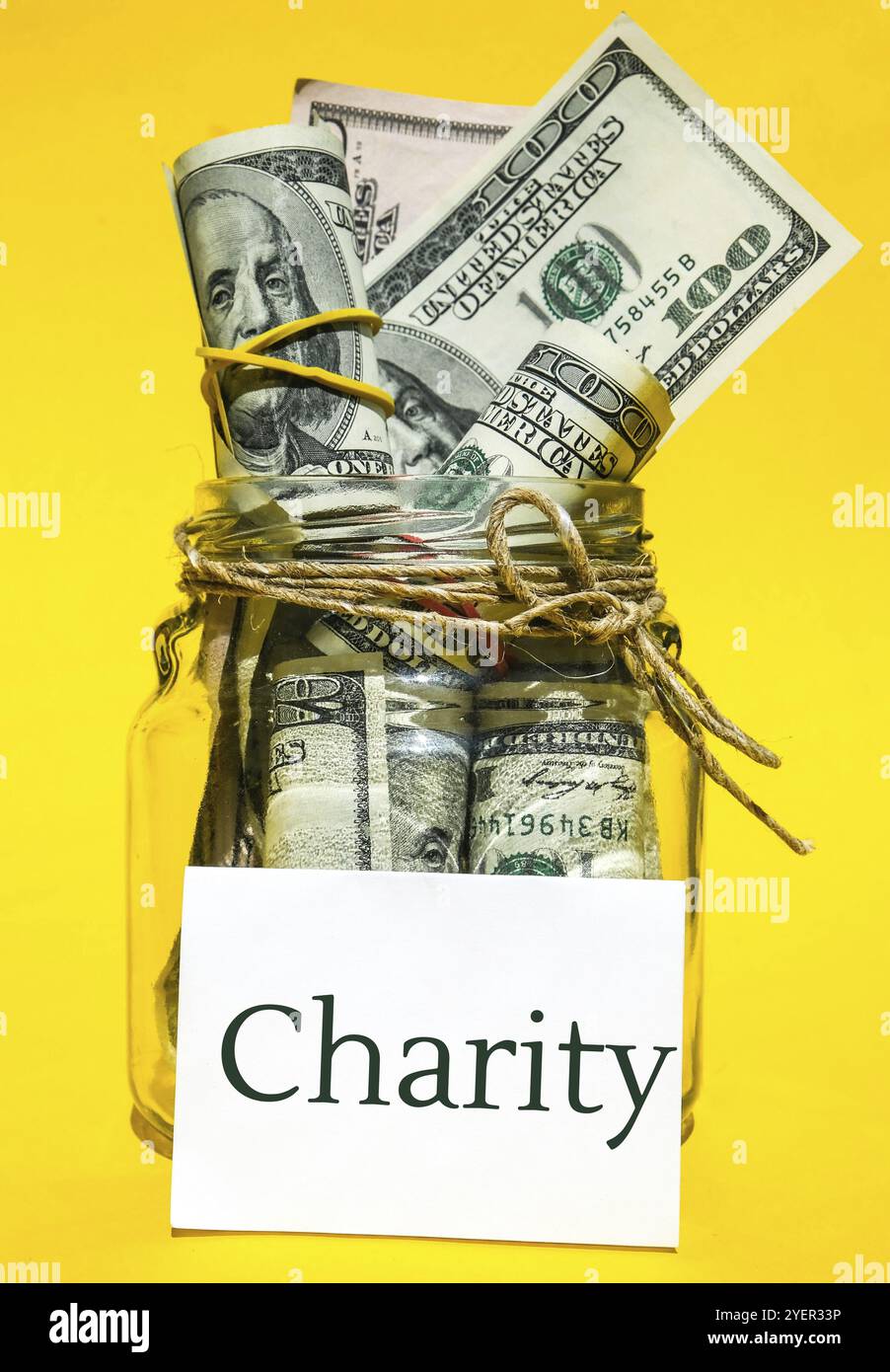 Paper note written word CHARITY in black letters around dollar ...