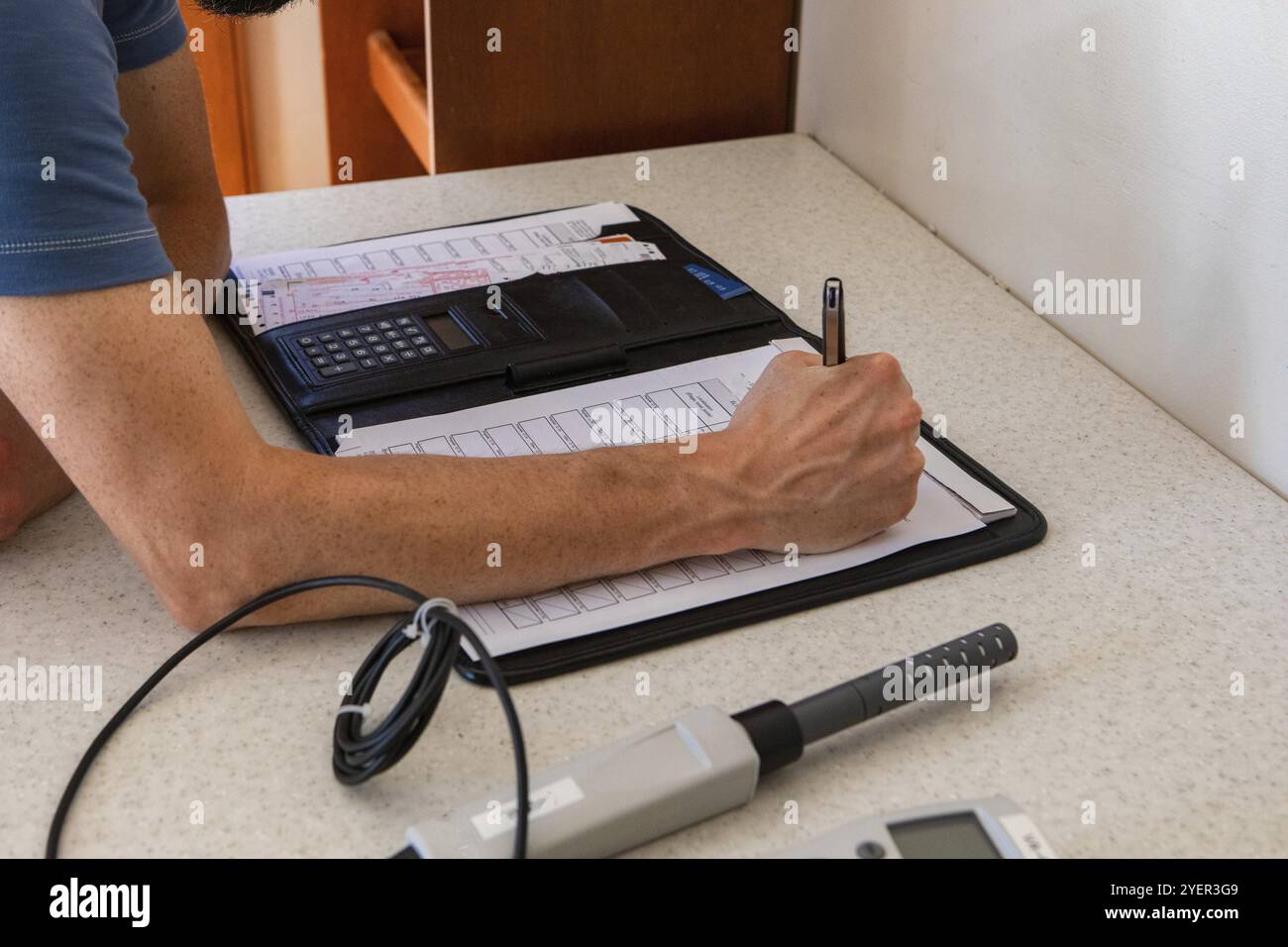 Construction professional uses measuring hi-res stock photography and ...